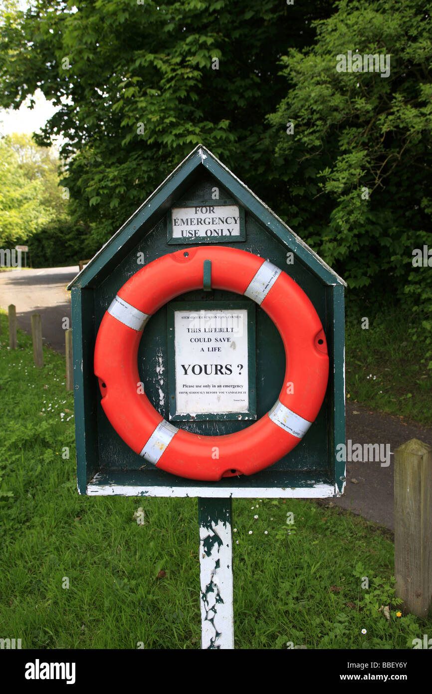 A life saving round ring or lifebelt situated at the edge of a river ...