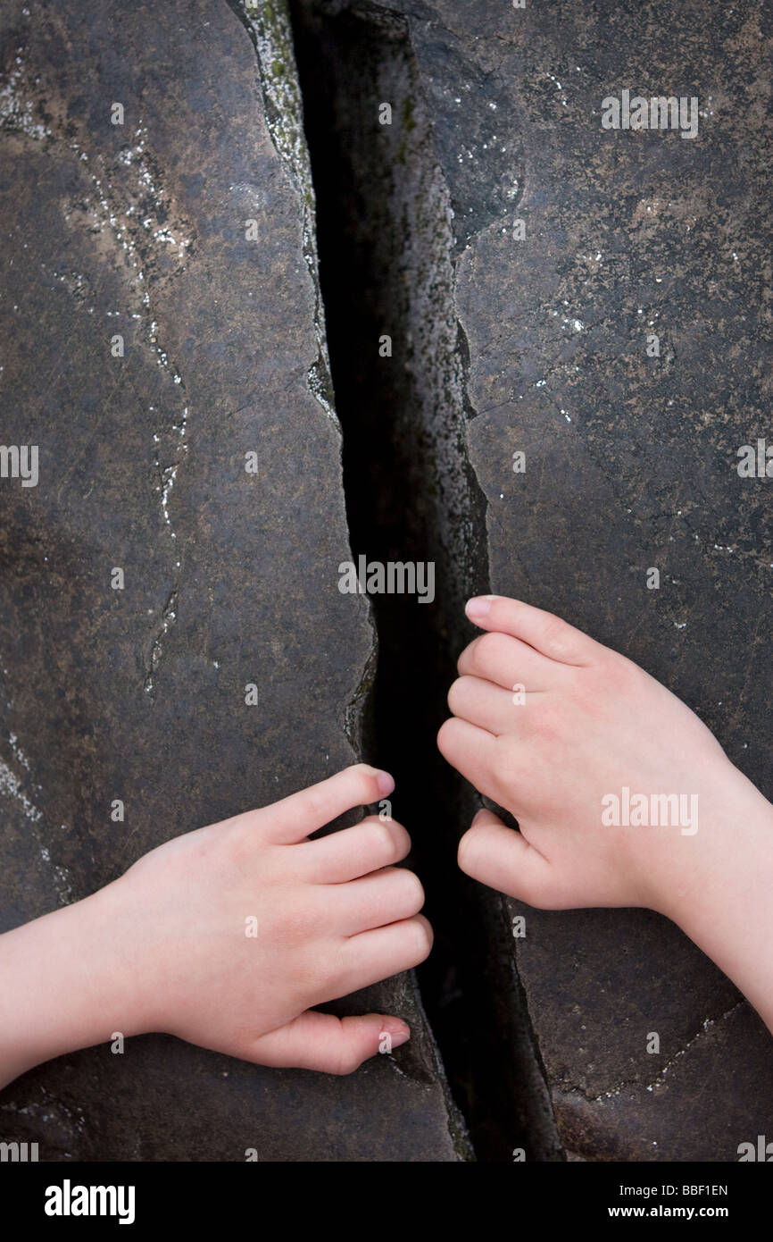 A child's Hands "Breaking" open a rock Stock Photo - Alamy