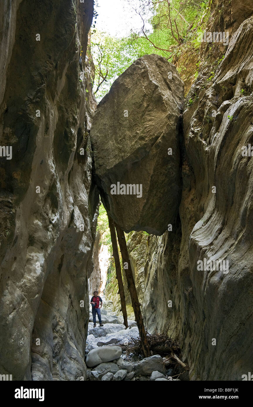 A huge fallen boulder wedged tight in the Ridomo Gorge In the Taygetos ...