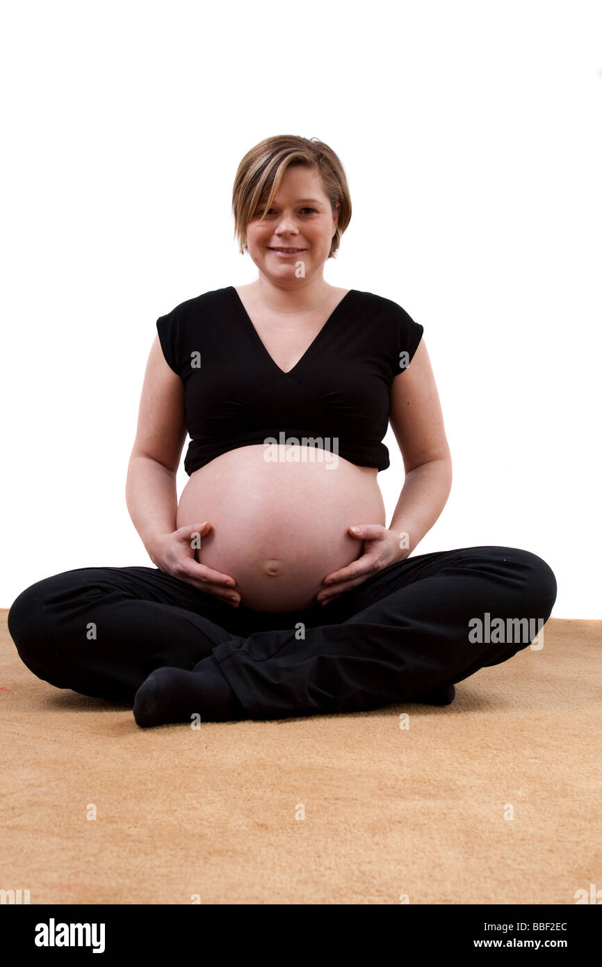 A happy caucasian woman sitting in the classic yoga pose Stock Photo ...