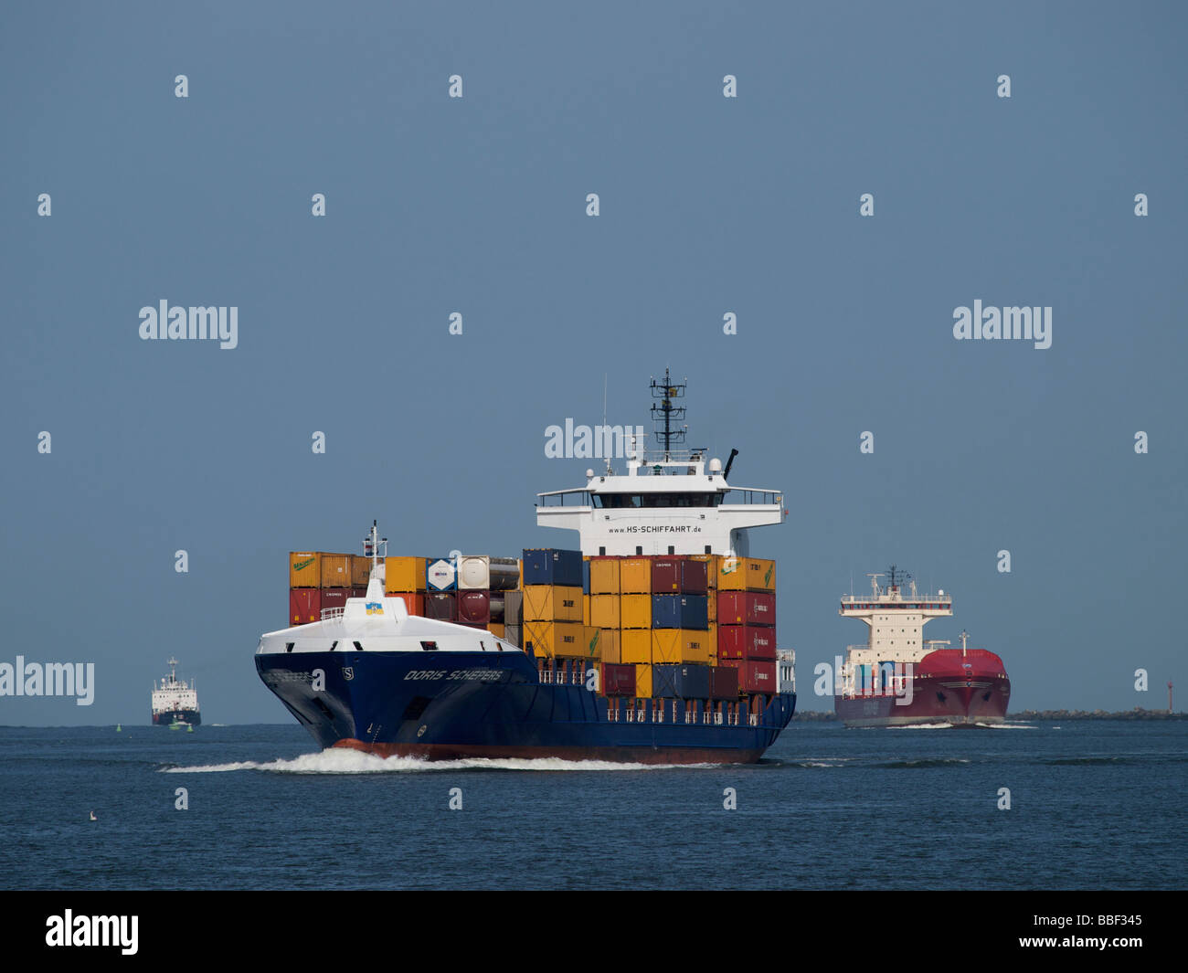 Three cargo ships approaching the port of Rotterdam carrying containers ...