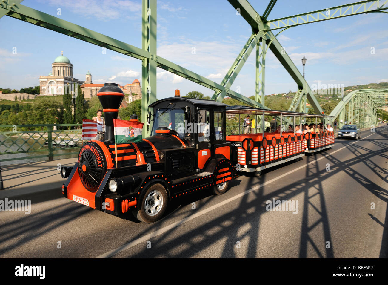 A sightseers train crosses the Maria Valeria Bridge with the Basilica ...
