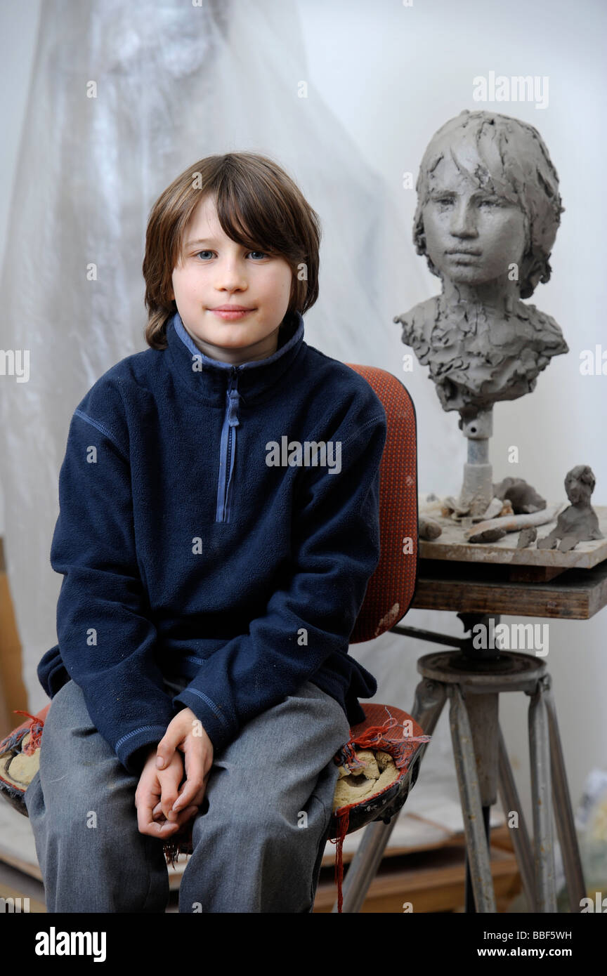 A young boy in an artists studio with a clay head 2008 Stock Photo - Alamy