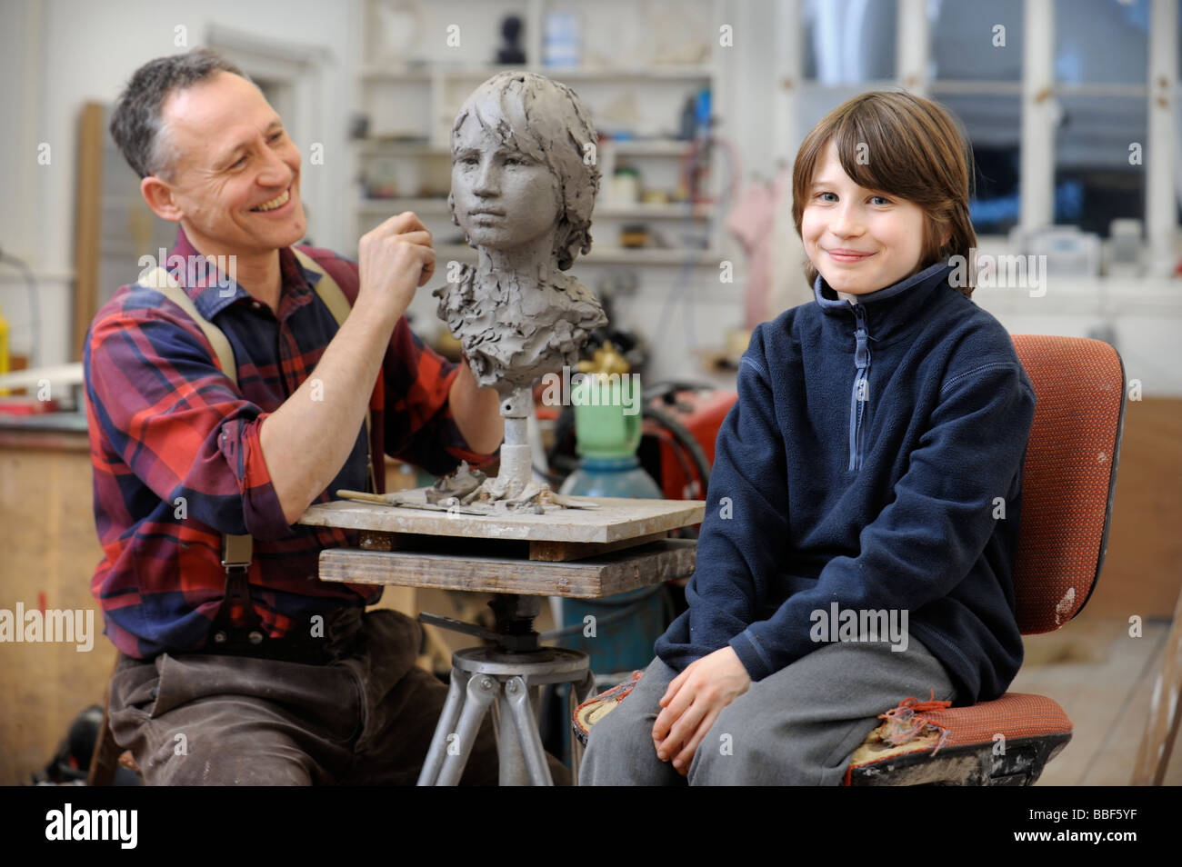 Sculptor Mark Richards in his studio near Ludlow working on a clay head ...