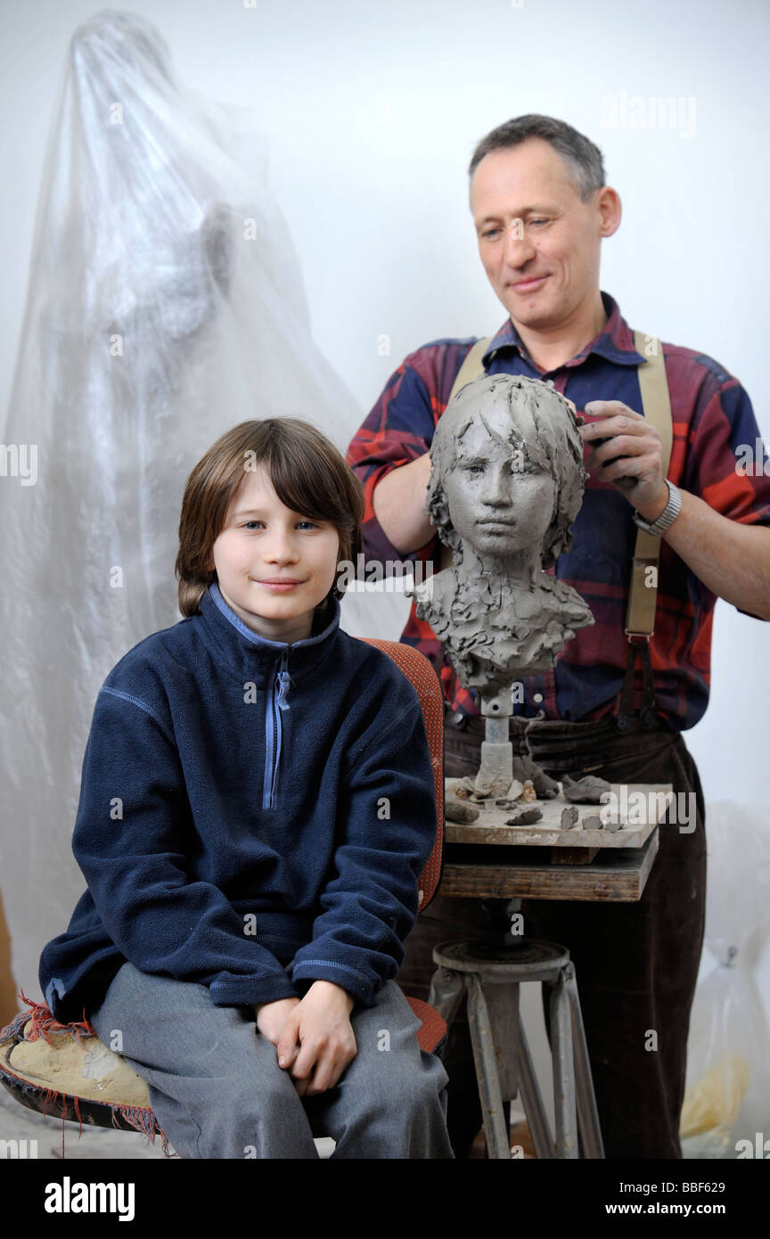 Sculptor Mark Richards in his studio near Ludlow working on a clay head ...