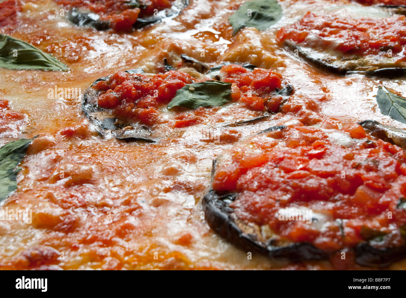 Close-up of a cheesy Melanzane pizza topped with eggplant Stock Photo ...