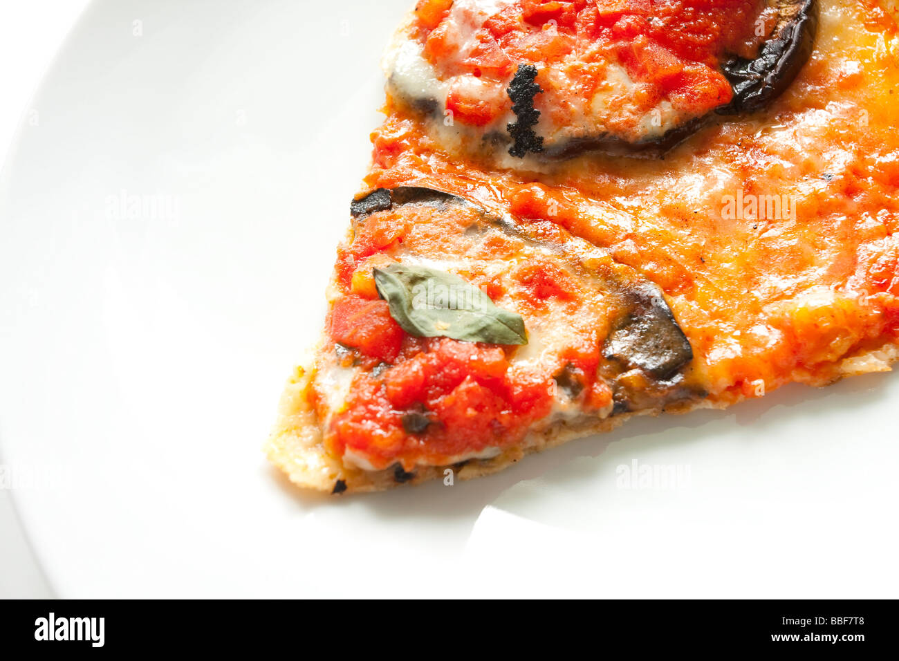 Eggplant Melanzane pizza slice on a white background Stock Photo - Alamy