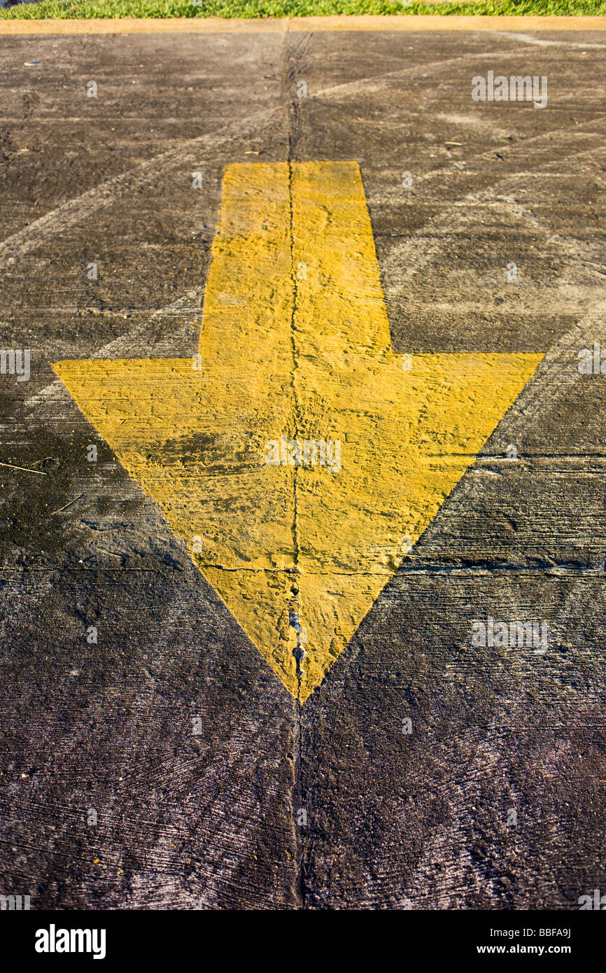 Yellow arrow on painted on heliport landing pad Stock Photo - Alamy