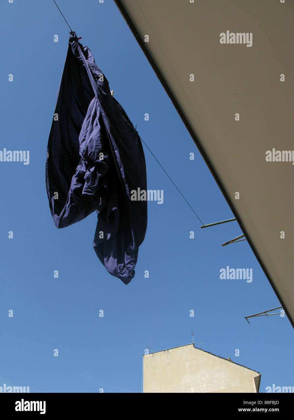 one blue bed sheet hanging on washing line in sun Stock Photo - Alamy
