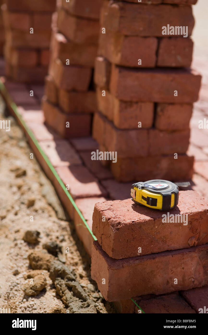 bricks and measuring tape Stock Photo - Alamy