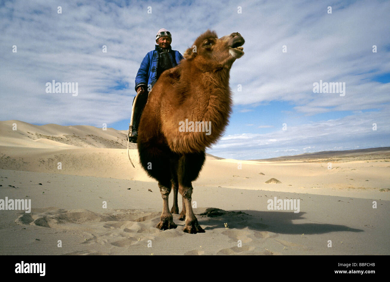 Oct 9, 2006 - Nomad on his Bactrian camel at the sand dunes of ...