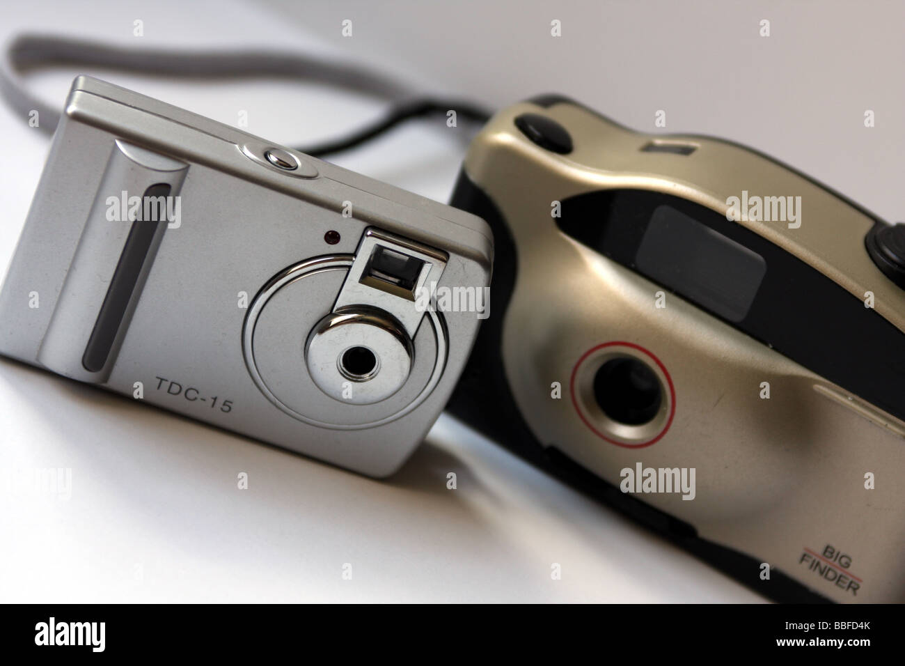 pocket digital camera beside a traditional pocket 35mm film based ...