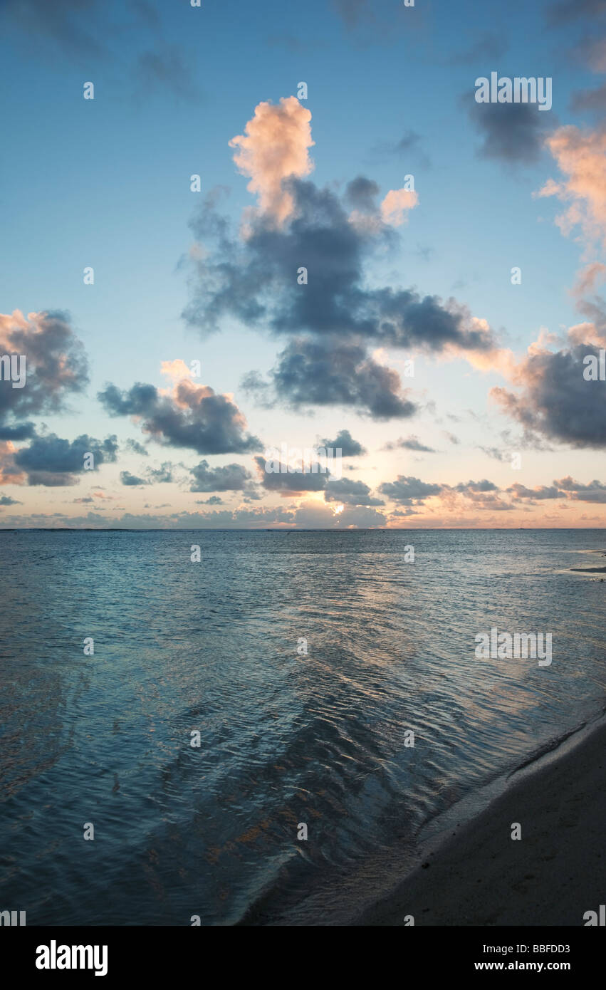 Sun setting behind Cumulus Clouds over Ocean and Island Rarotonga Cook ...