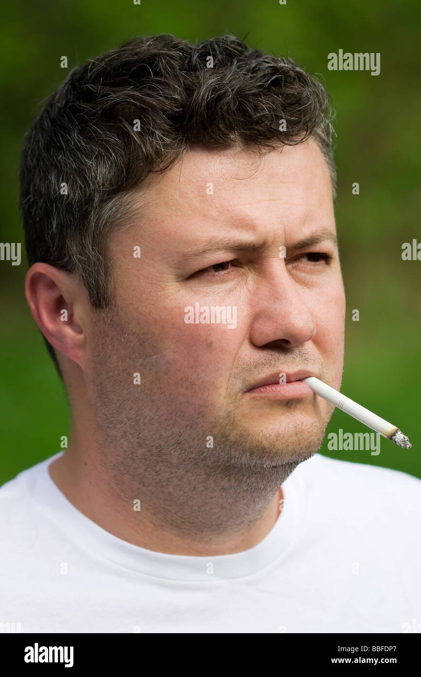 Portrait unshaven man smoking cigarette hi-res stock photography and ...