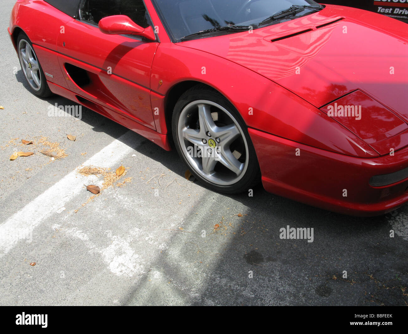 one red ferrari sports car in street in rome italy Stock Photo - Alamy