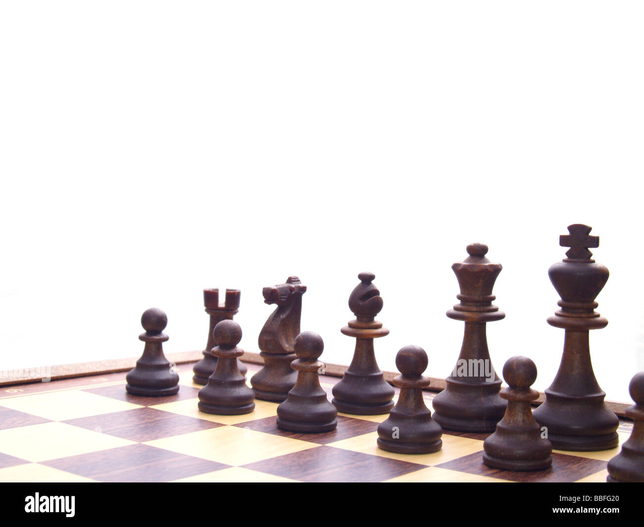 black chessmen on chess board in the beginning of game Stock Photo - Alamy