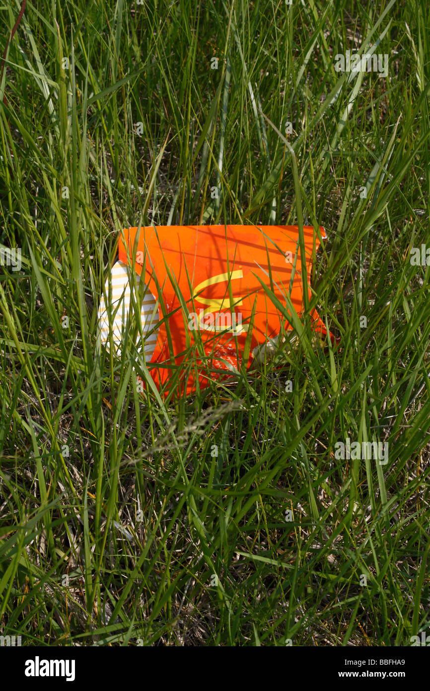 Polluted nature with rubbishThrowing waste into green nature close up ...