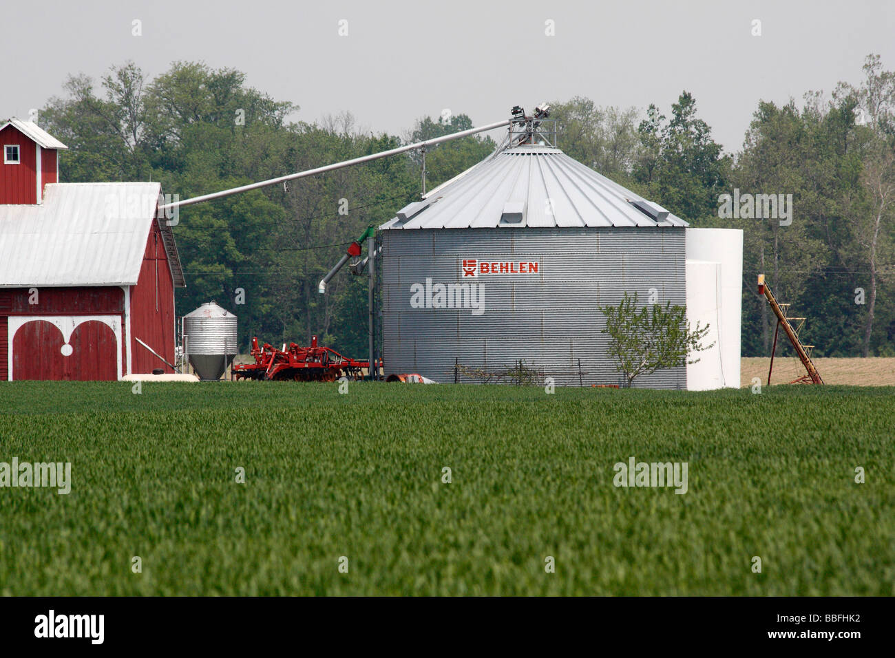 American rural farming with green wheat field and grain silo in OH USA ...