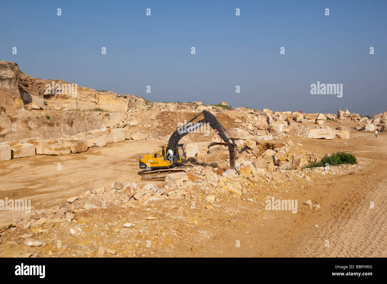Power hammer chipping away for blocks of marble at an open pit mine in ...