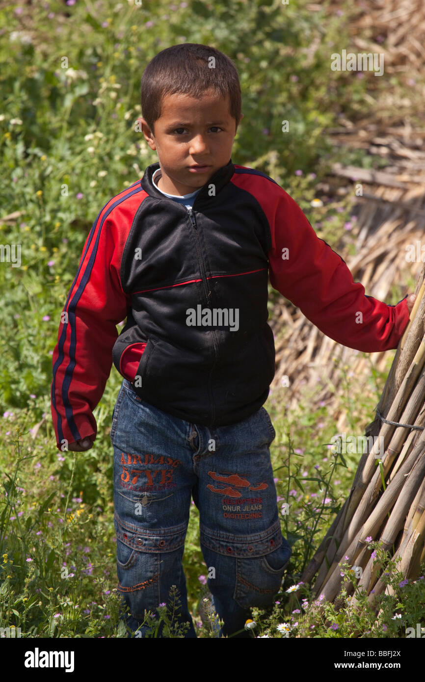 Young gypsy boy poses next to a pile of cane in western Turkey Stock ...
