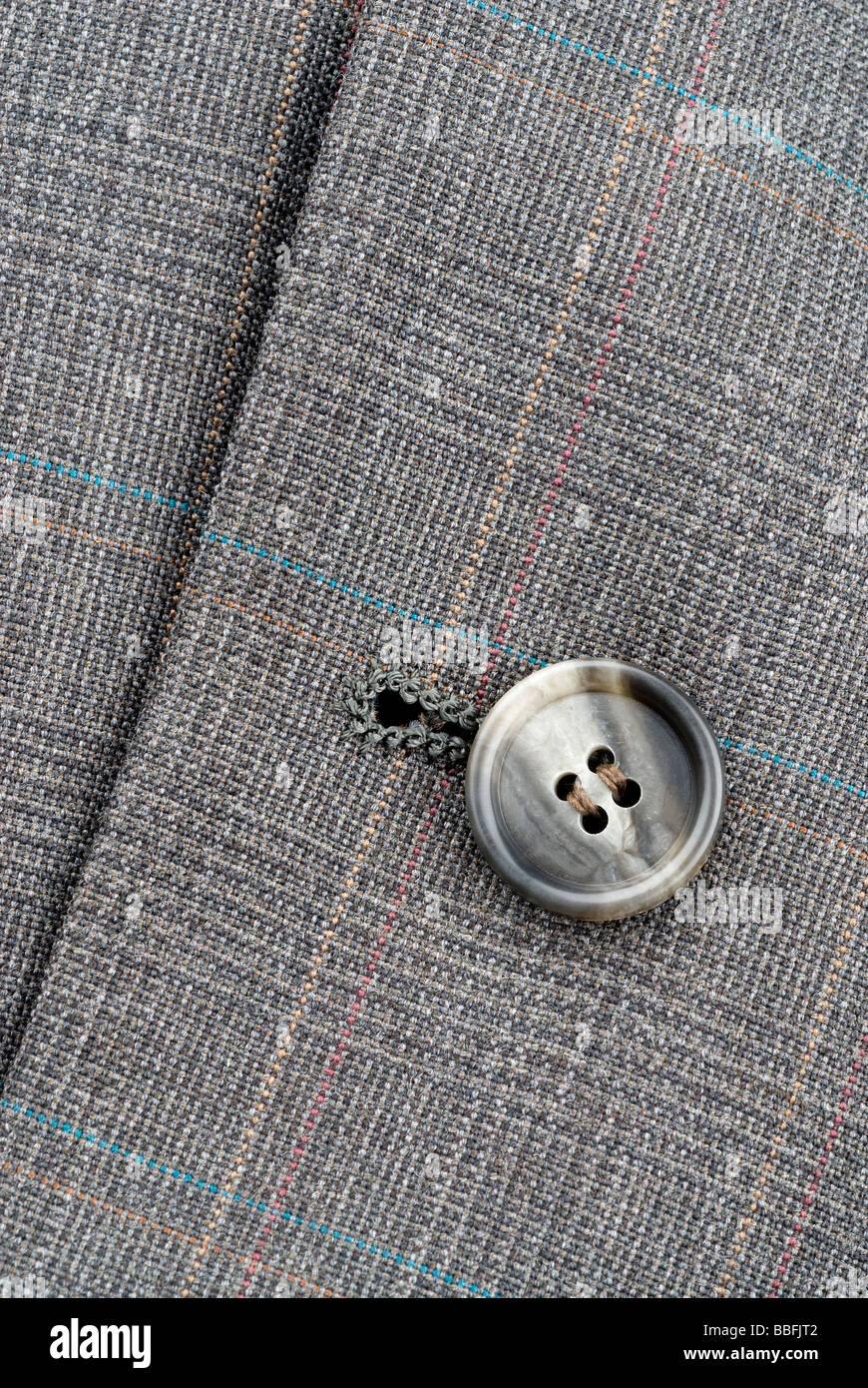 A button on a business suit shows the fine tailoring detail Stock Photo ...