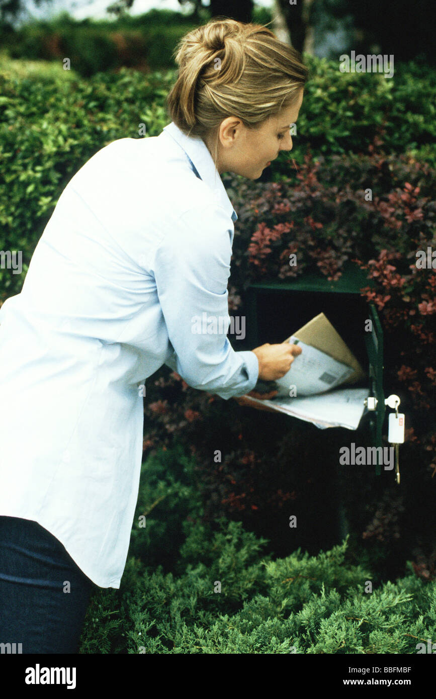Woman checking mail Stock Photo - Alamy