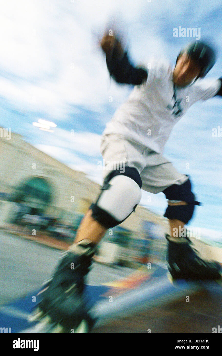 Inline skater sliding on ramp at skatepark Stock Photo - Alamy