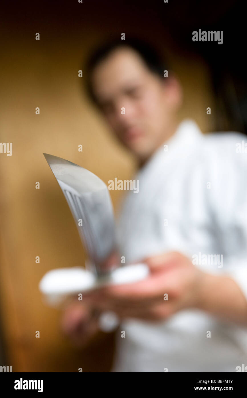 Sadanori Tanaka a swordsmith for 18 years works on a sword in his forge ...