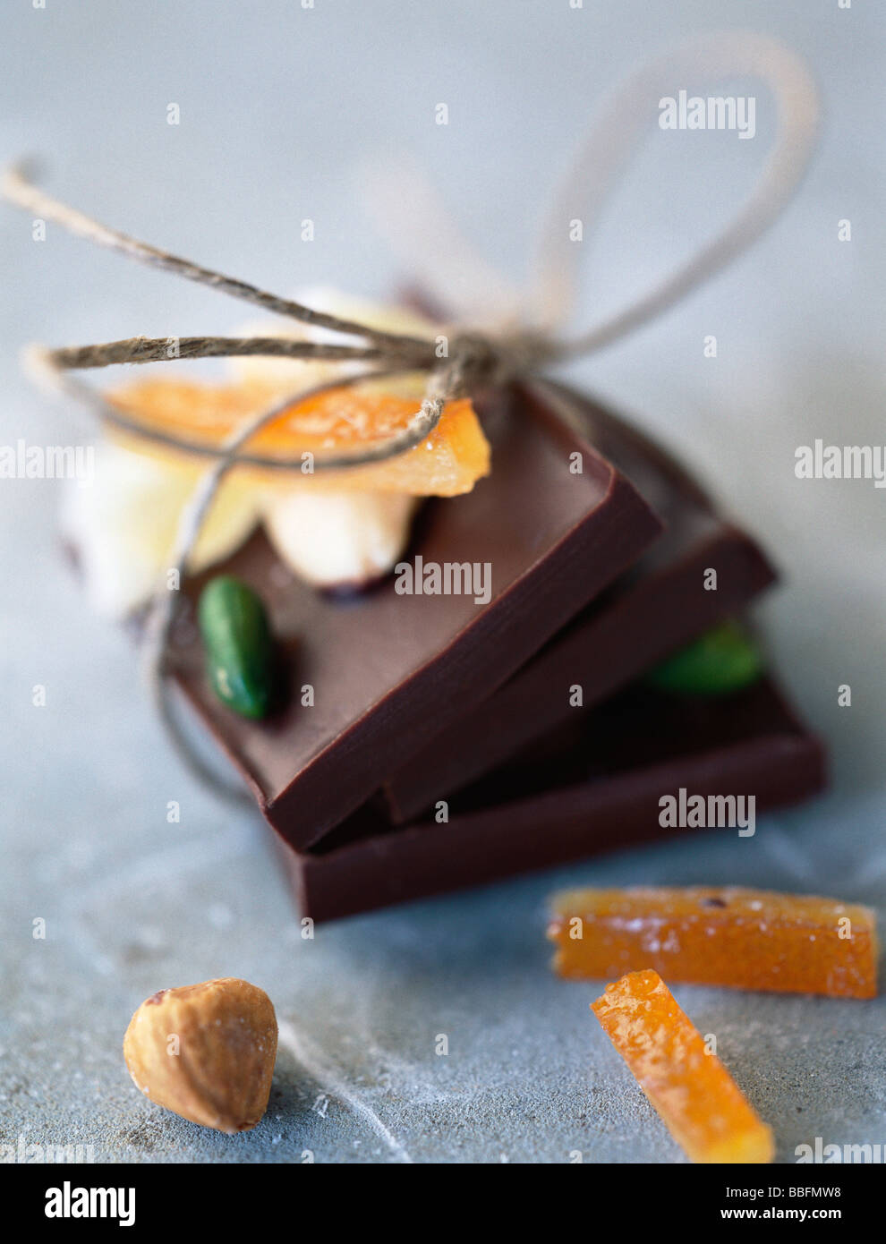 Chocolate bars tied together with string, candied fruit, hazelnut Stock ...