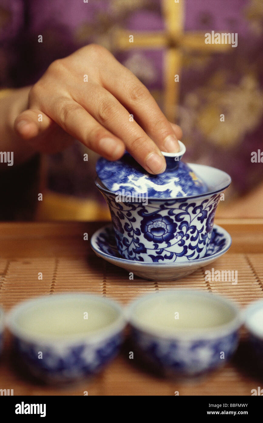 Hand placing tea hi-res stock photography and images - Alamy