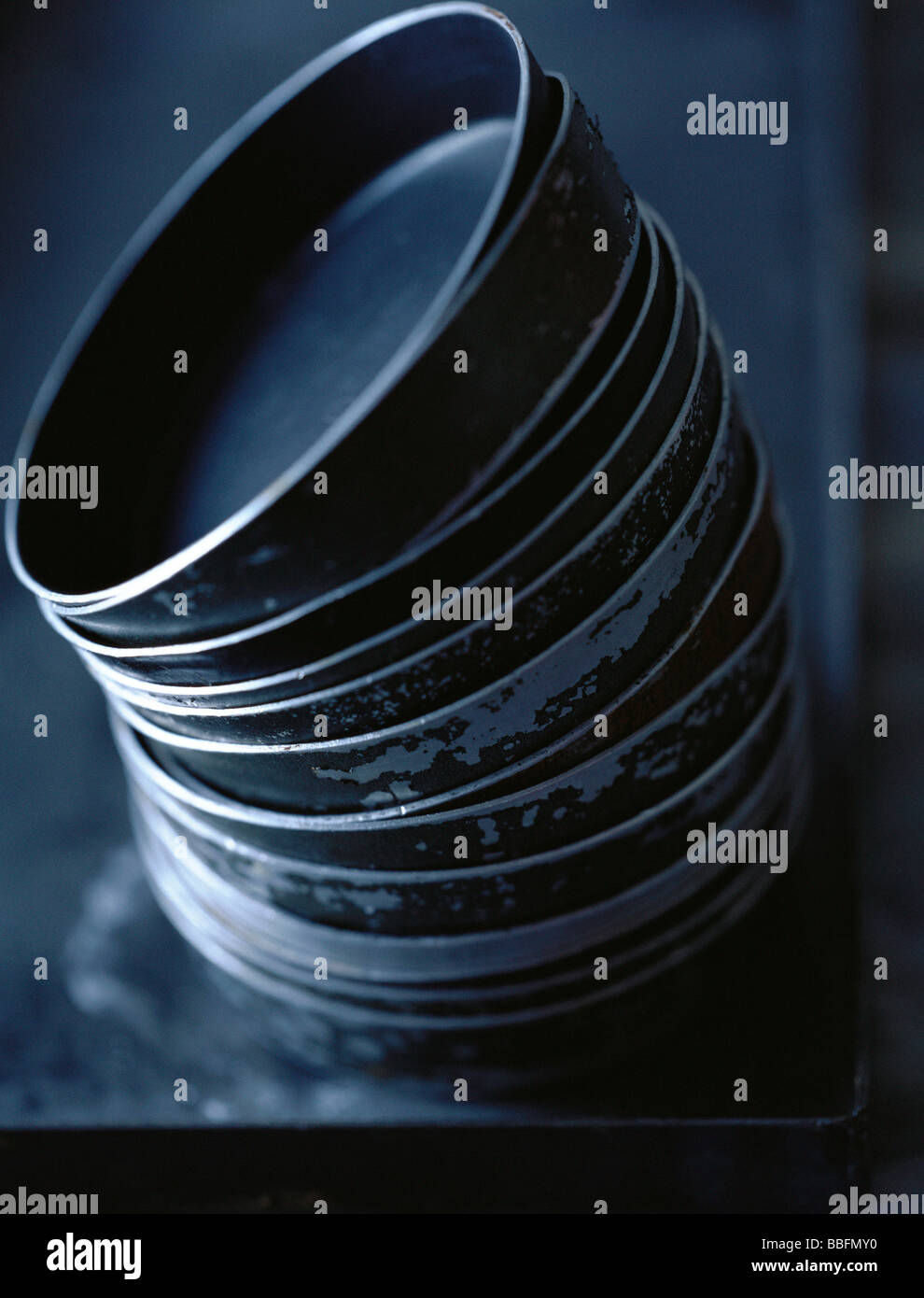 Leaning stack of baking pans Stock Photo - Alamy