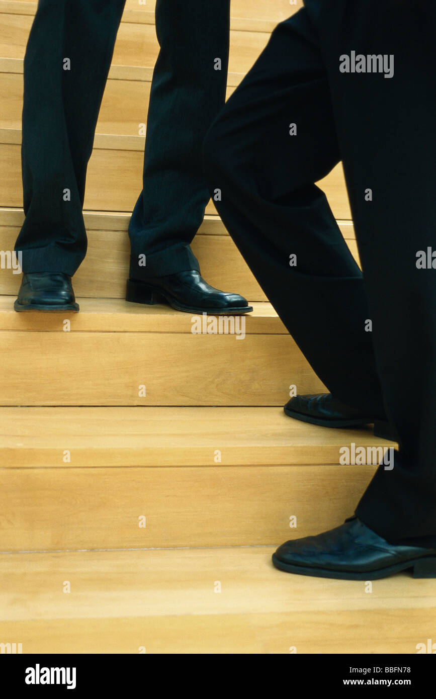 Businessmen standing on steps, low-section Stock Photo - Alamy