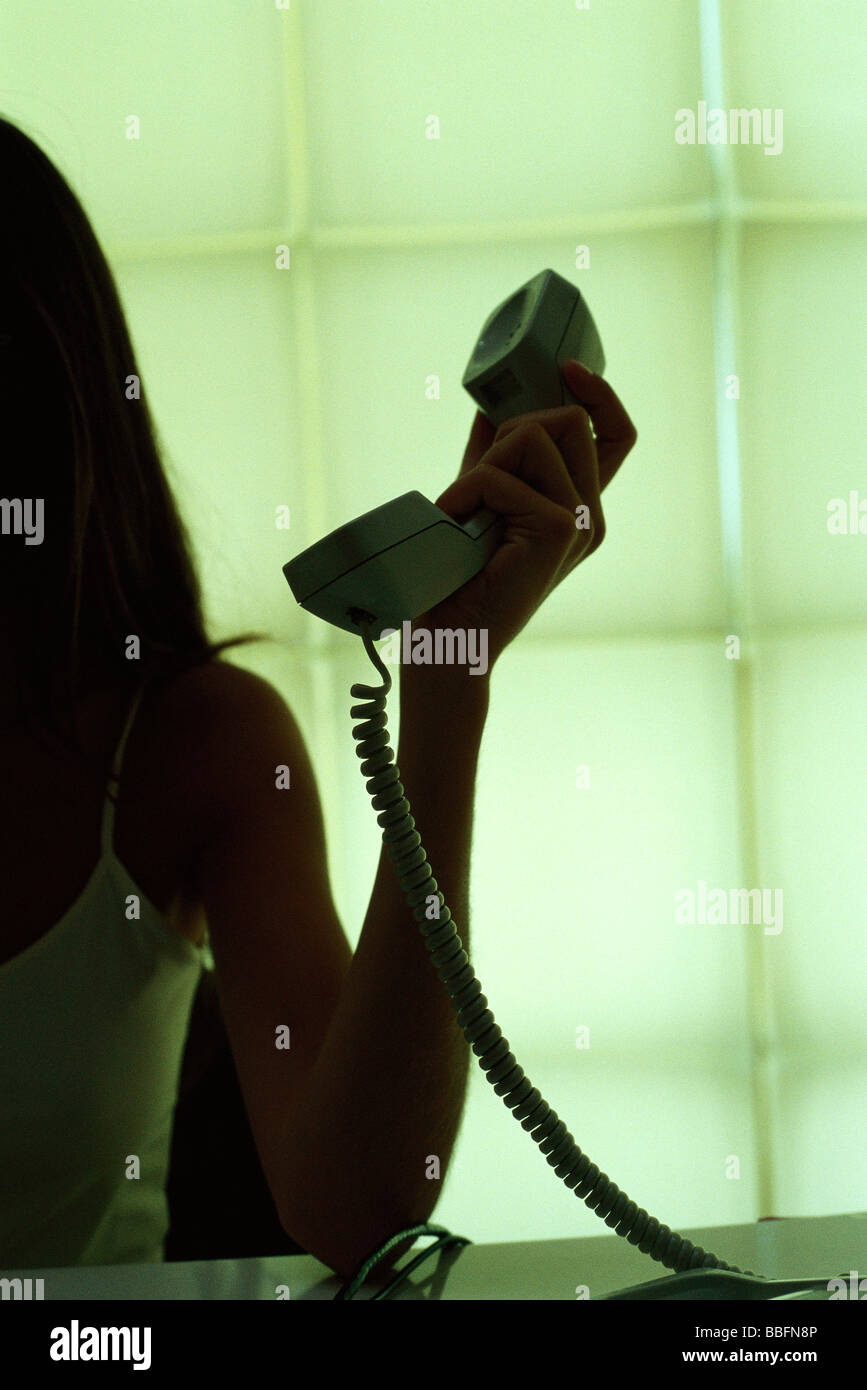 Woman holding landline phone receiver, cropped view Stock Photo - Alamy