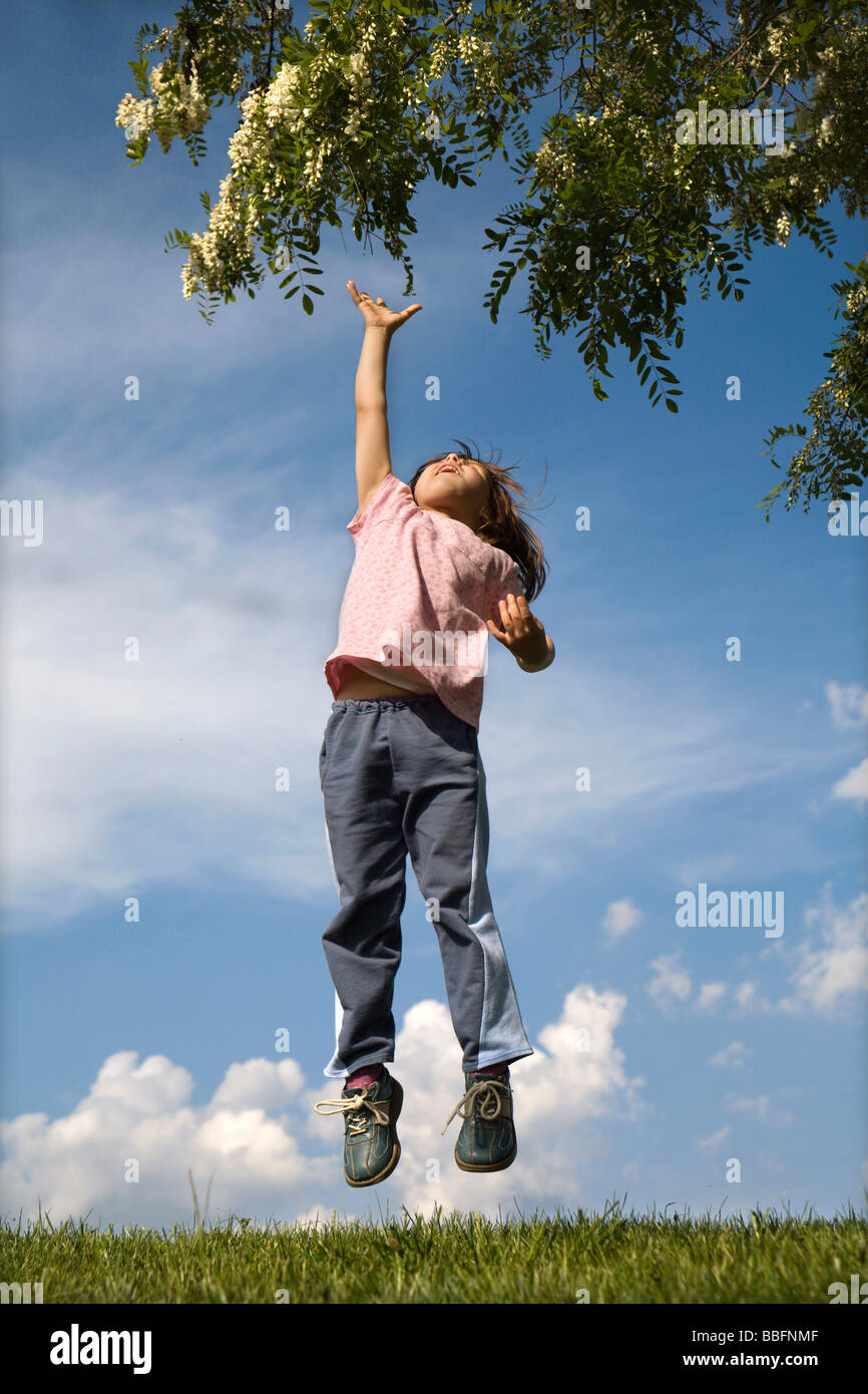 jump of little girl and tree in the spring Stock Photo - Alamy