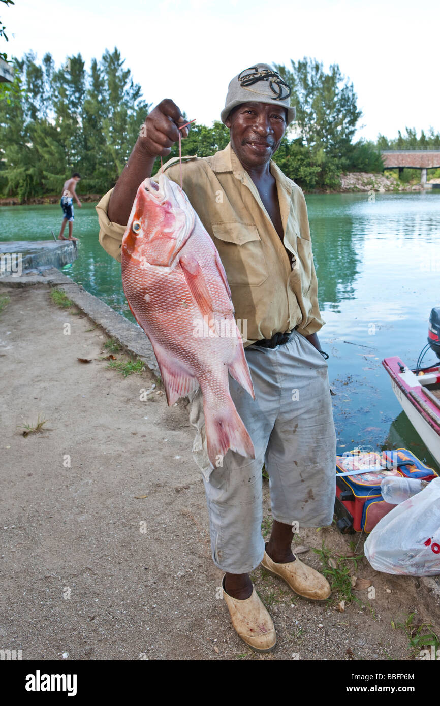 A fisherman presenting his freshly caught fish, Mahe Island, Seychelles ...