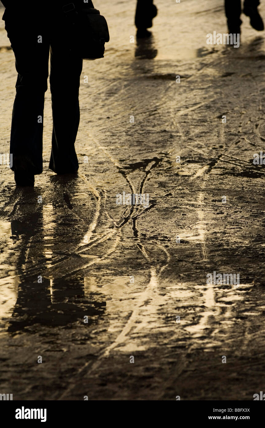 Puddles, skid marks and footprints after a rainshower Stock Photo - Alamy