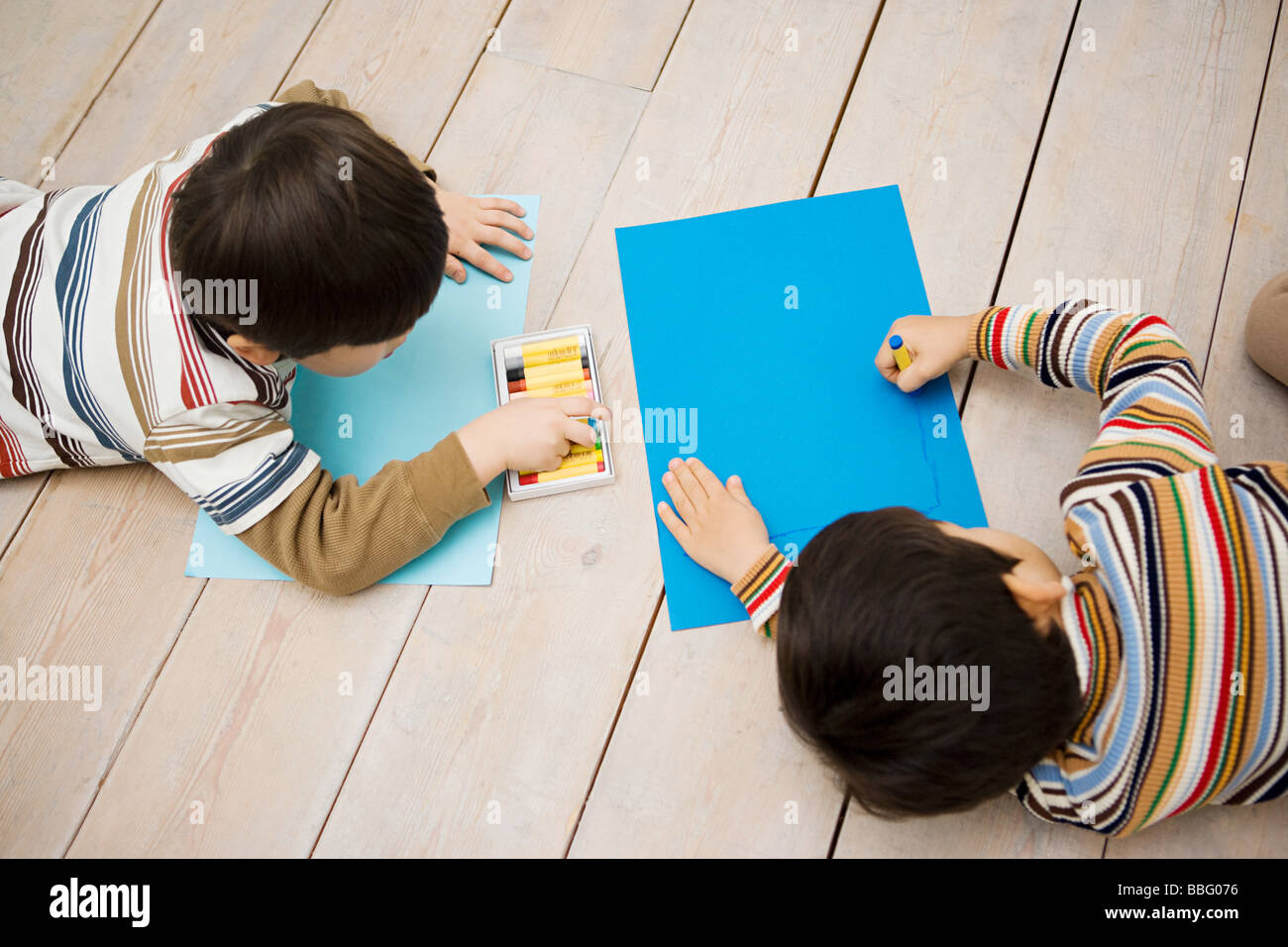Boys drawing with crayons Stock Photo - Alamy