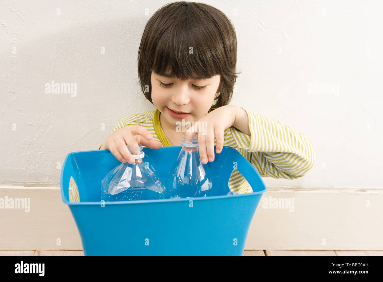 A boy holding a recycling bin Stock Photo - Alamy