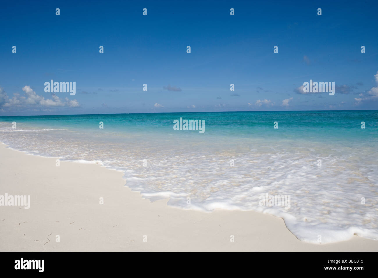 Waves on sandy beach Stock Photo - Alamy