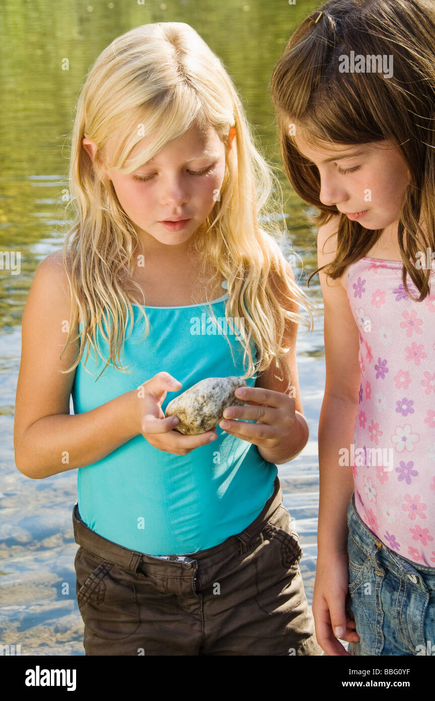 Girls with a rock Stock Photo - Alamy