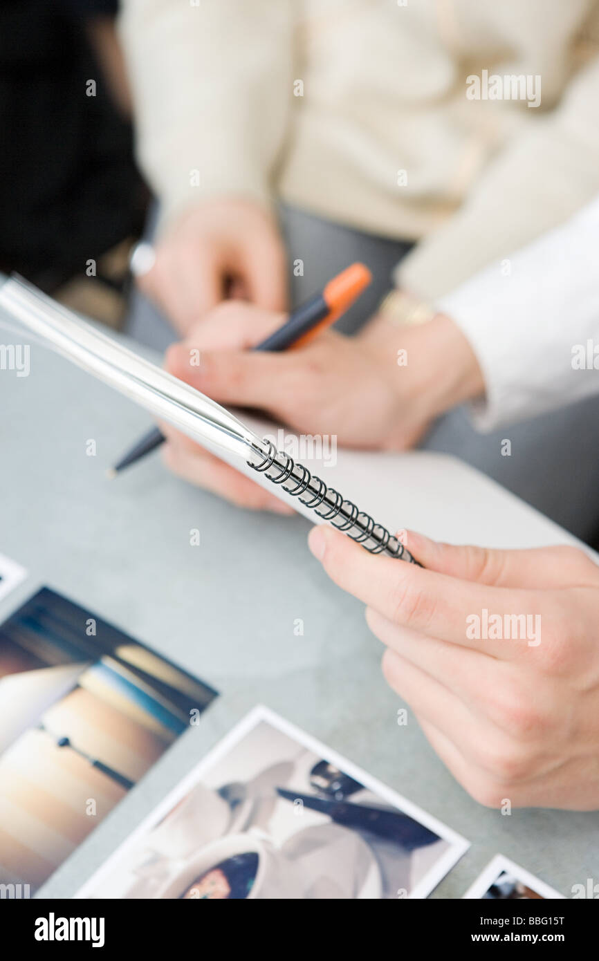 People with notepad and photographs Stock Photo - Alamy