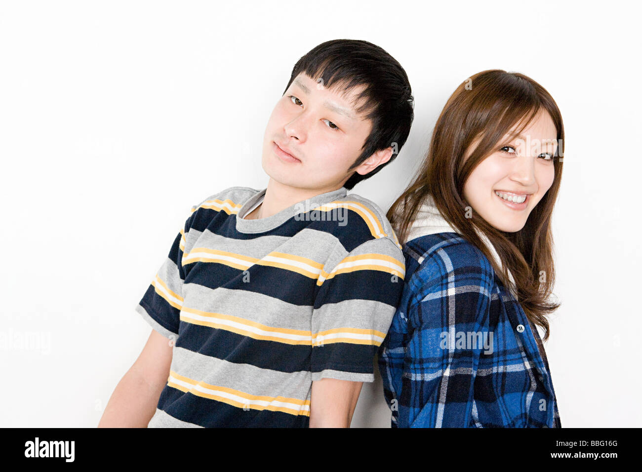 Young couple back to back Stock Photo - Alamy