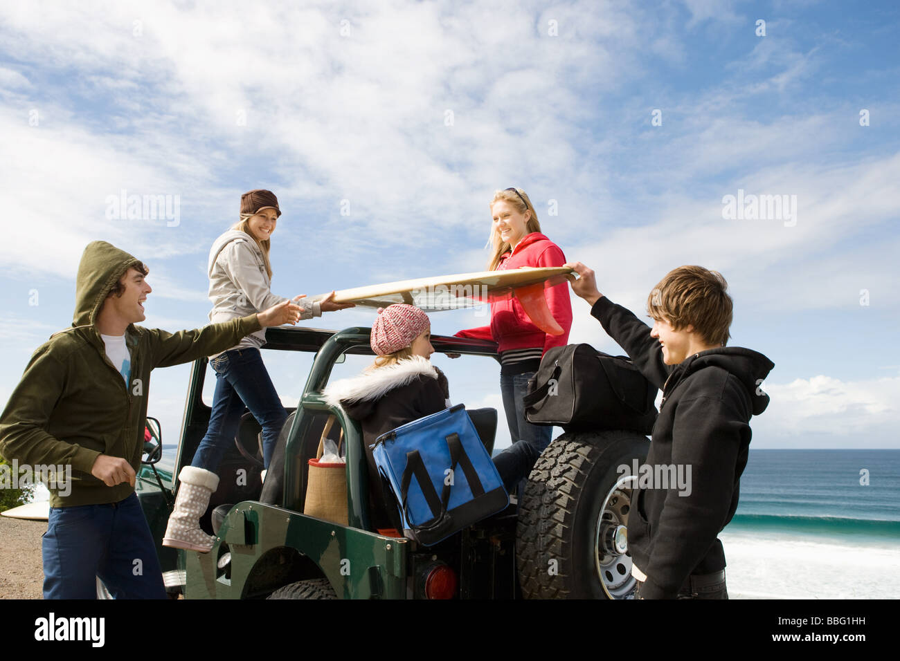 Surfer friends at the coast Stock Photo - Alamy