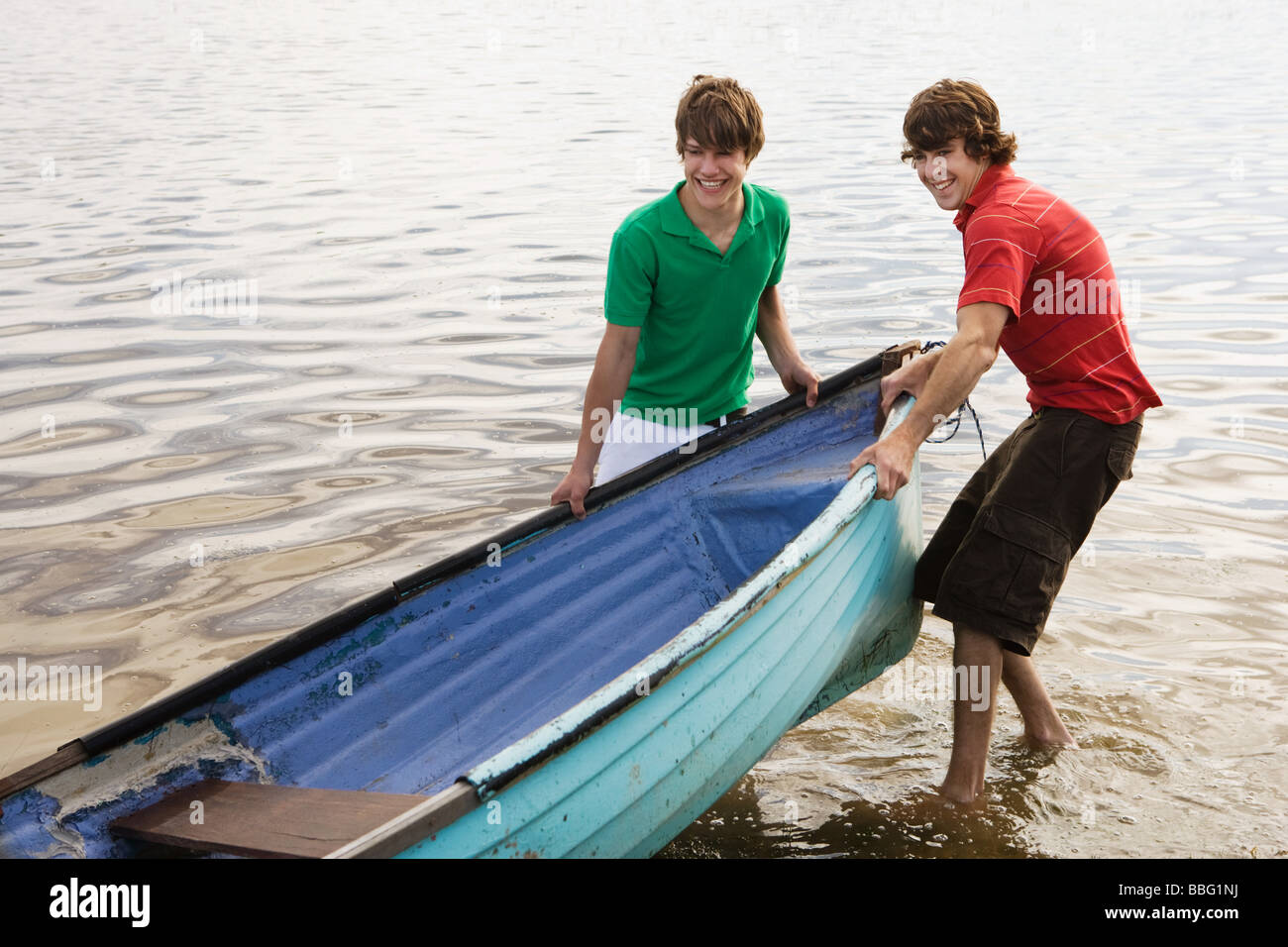 Friends with rowboat Stock Photo - Alamy