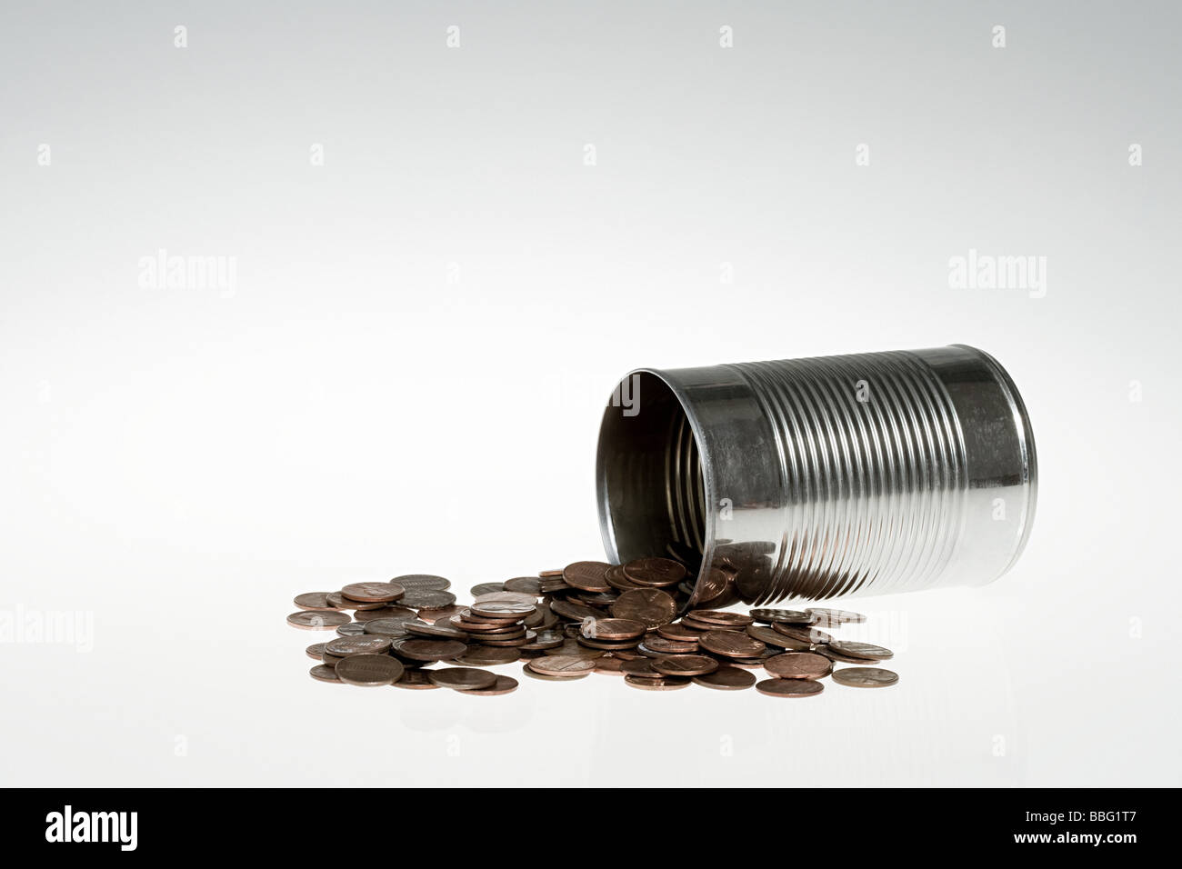 Coins and can Stock Photo - Alamy