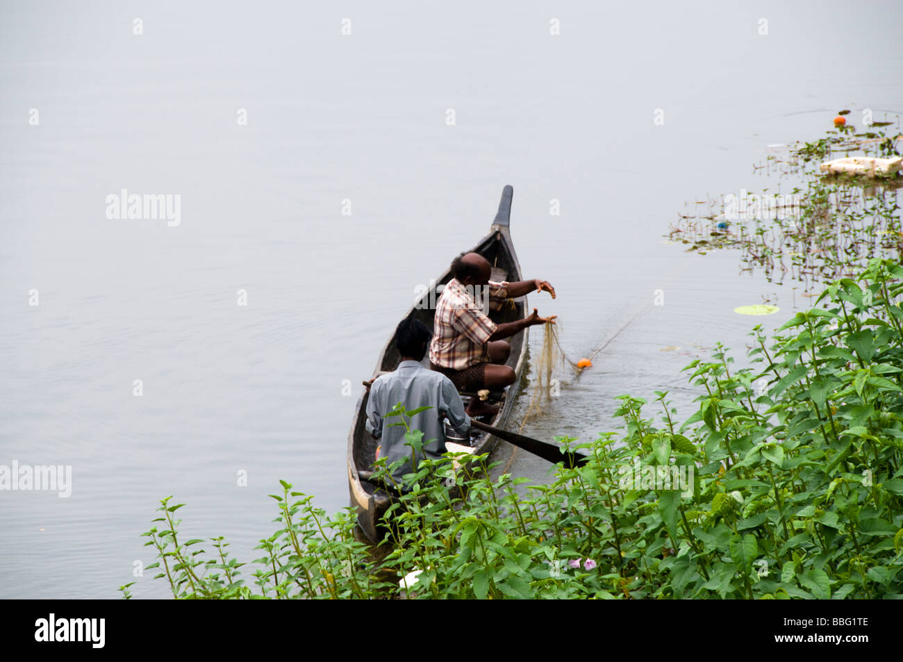 Fisherman fishing in backwaters kerala india Stock Photo - Alamy