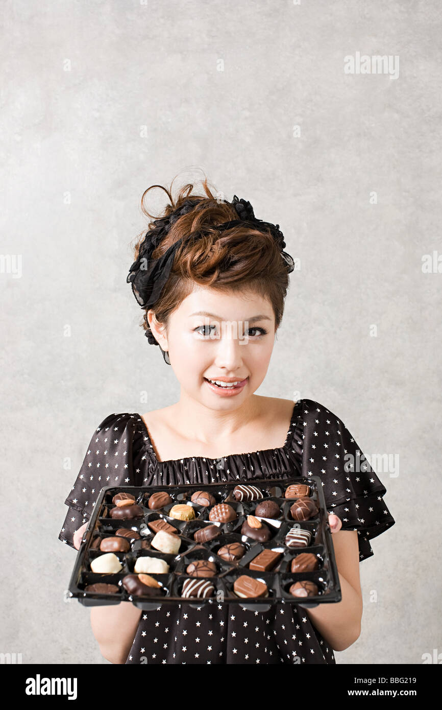 Woman with tray of chocolates Stock Photo - Alamy