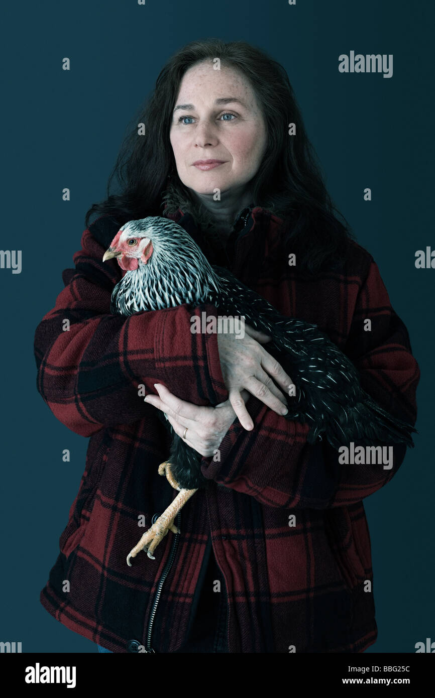 Woman holding a chicken Stock Photo - Alamy