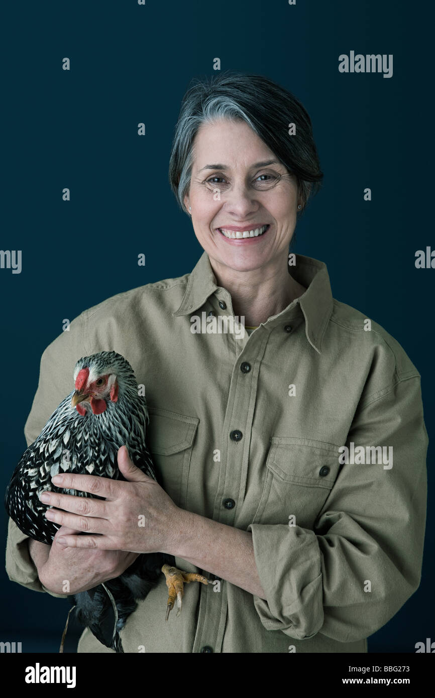 Woman holding a chicken Stock Photo - Alamy