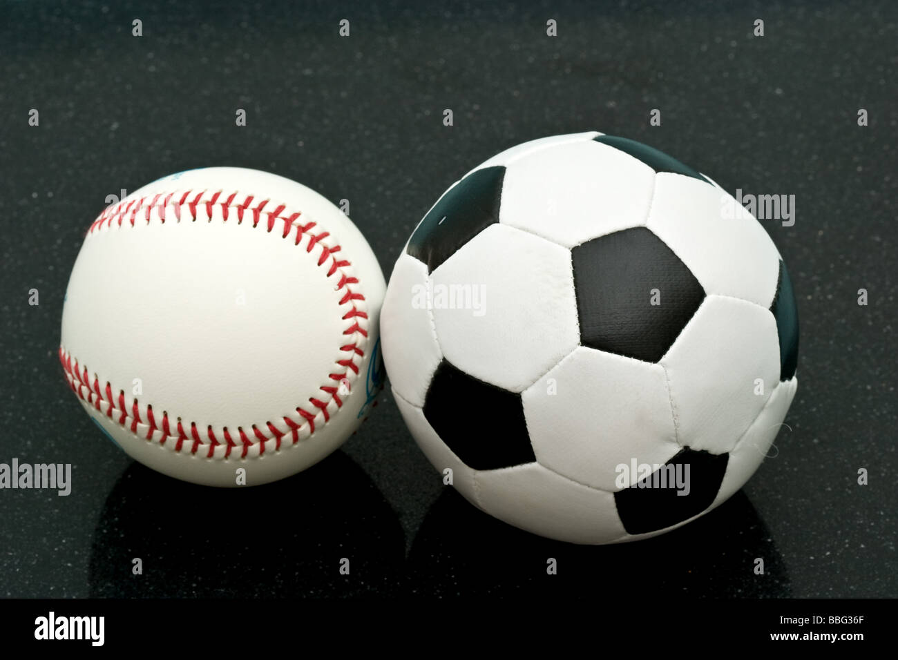 Soccer ball and a baseball touching Stock Photo - Alamy